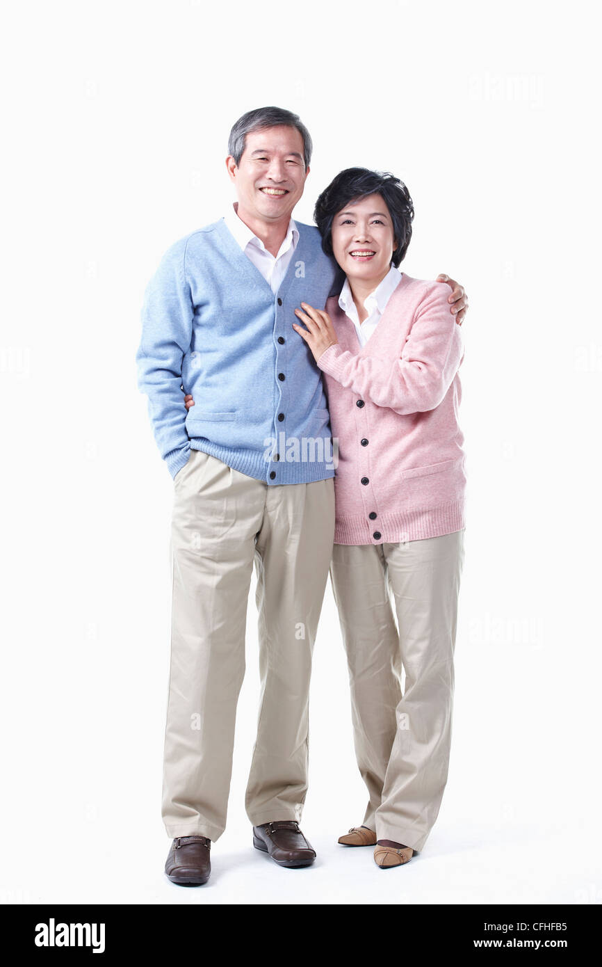 An elderly man and woman putting arms around on each other Stock Photo ...
