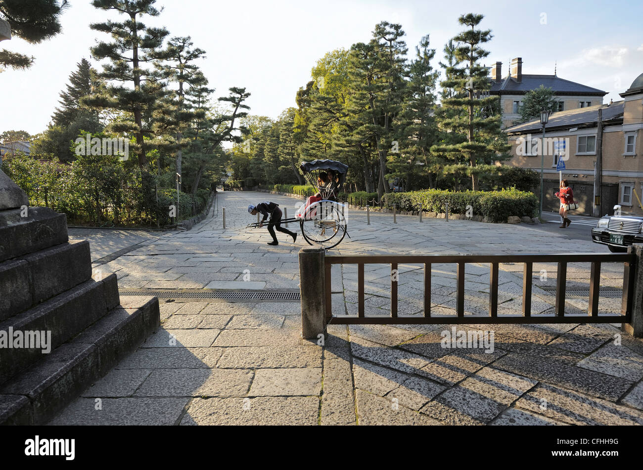 young Japanese man pulling a rickshaw with two women, Kyoto, Japan ...