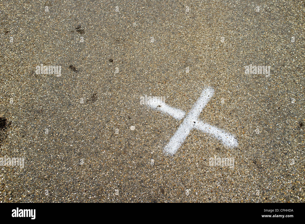 A cross spray painted on the ground Stock Photo - Alamy