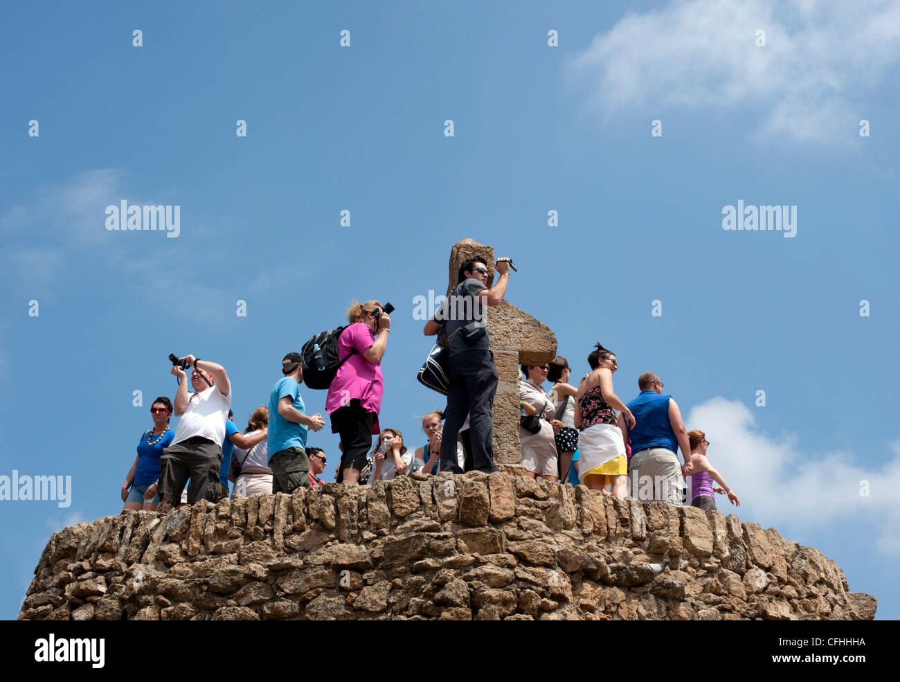 Tourists crowd at a high view point taking photos in all directions ...