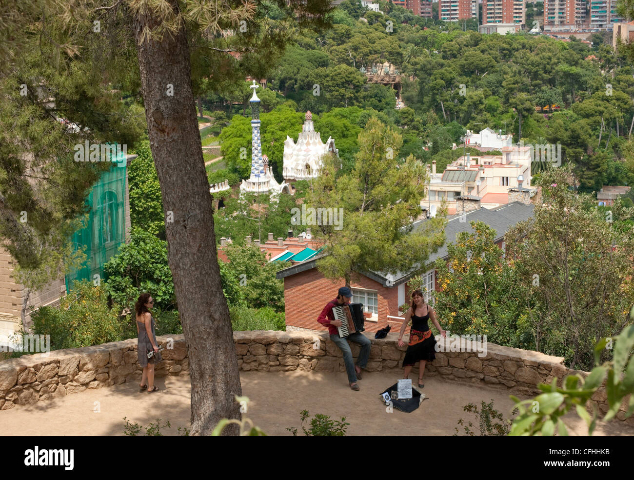 Musicians sing and play accordian on the terraced walkway in Park Guell ...