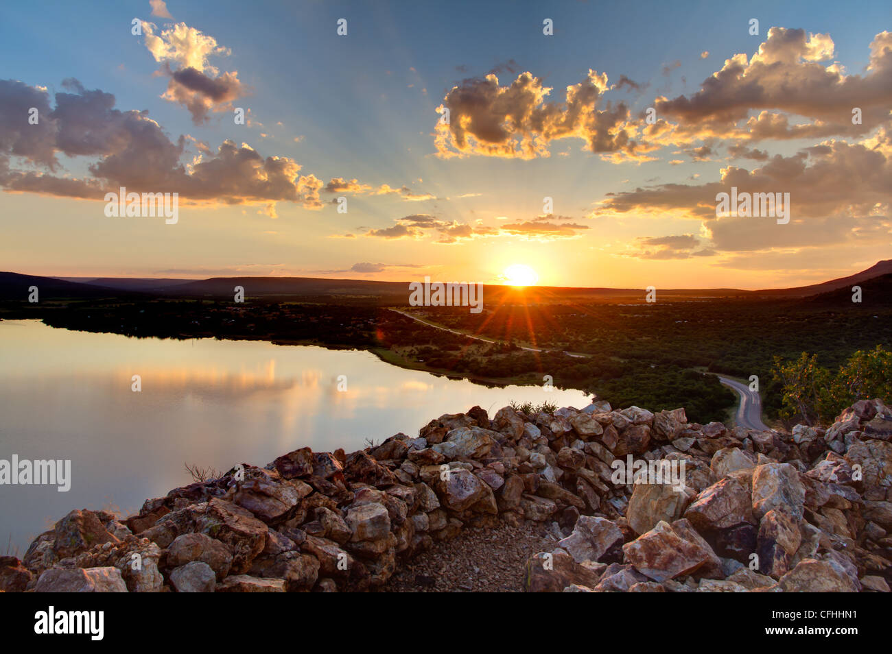Sunset over dam and mountain Stock Photo - Alamy