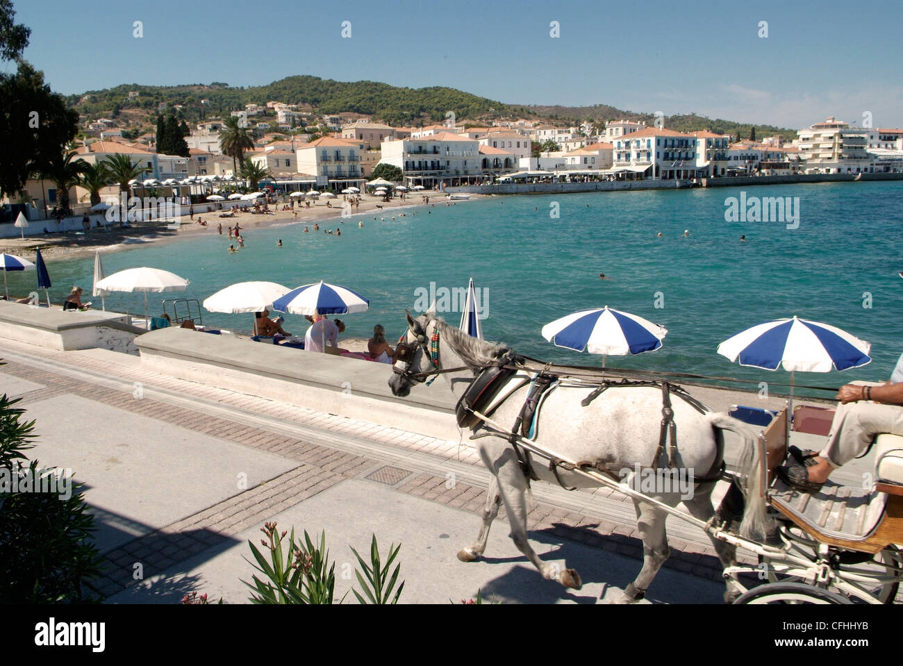 GREECE Saronic Gulf Island of Spetses beach and town with horse drawn ...