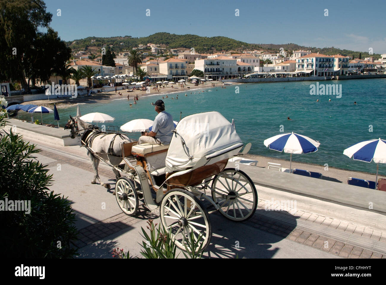 GREECE Saronic Gulf Island of Spetses beach and town with horse drawn ...