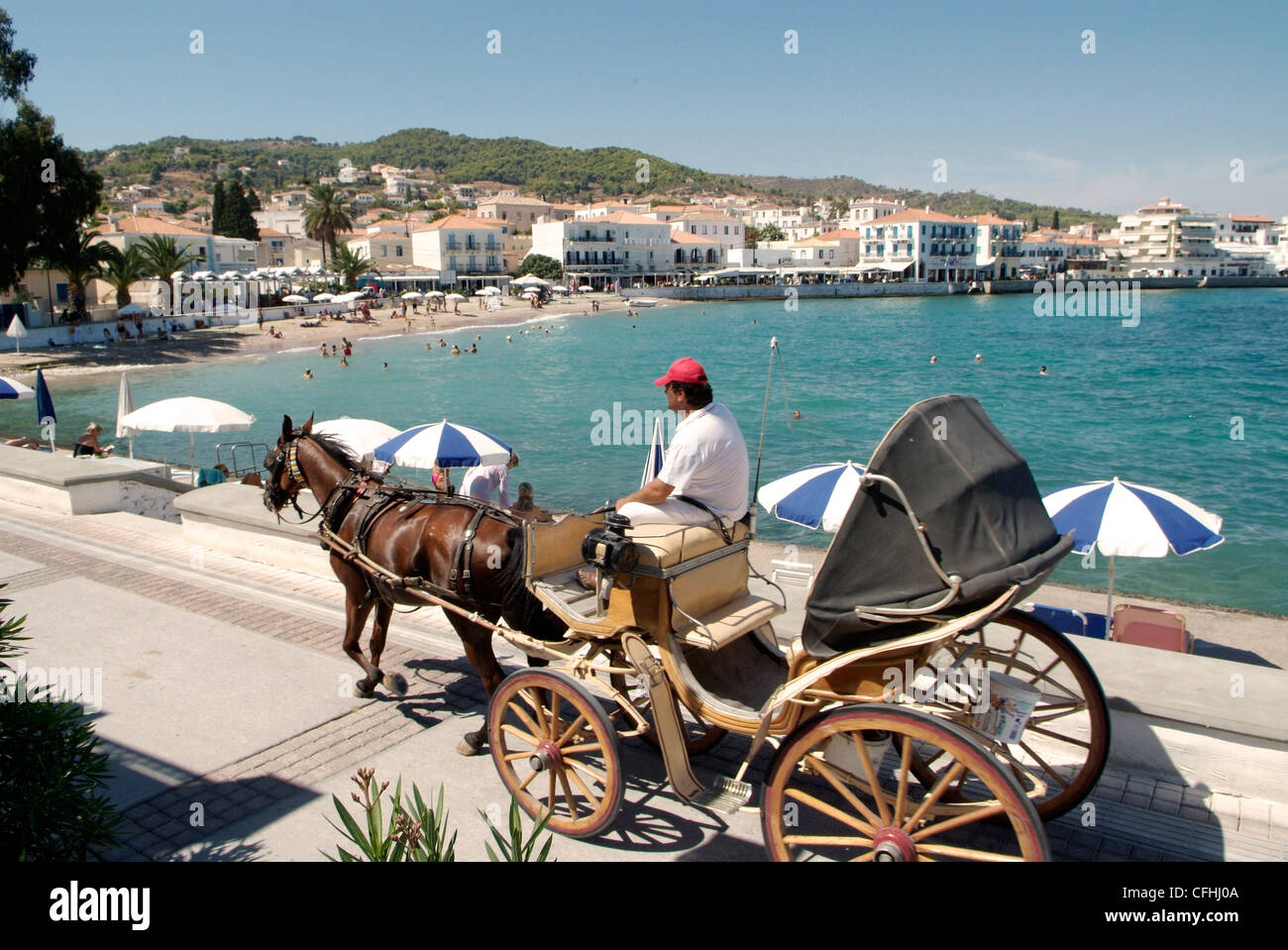 GREECE Saronic Gulf Island of Spetses beach and town with horse drawn ...