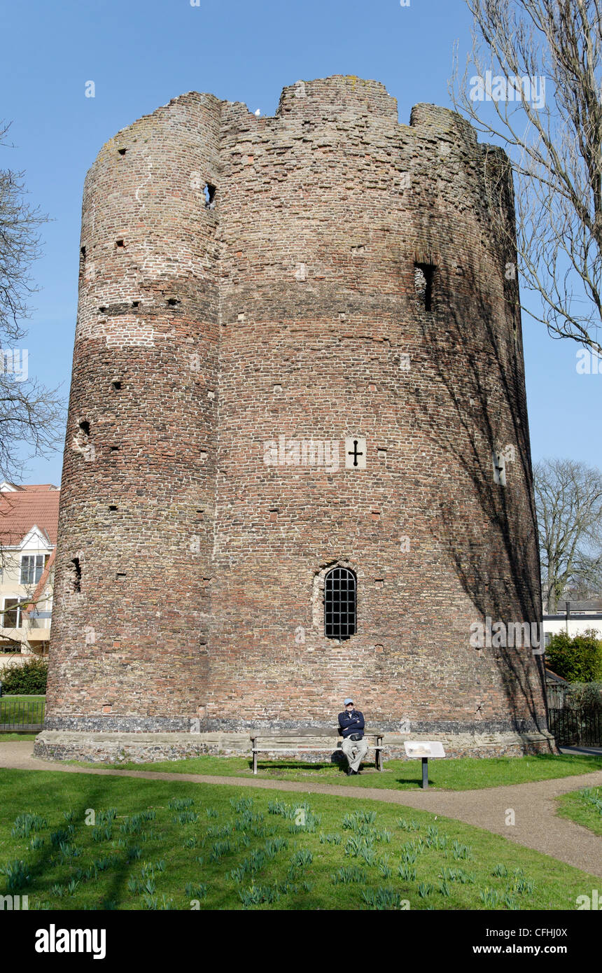 Man sitting in the sun outside the Cow Tower, historic old military ...