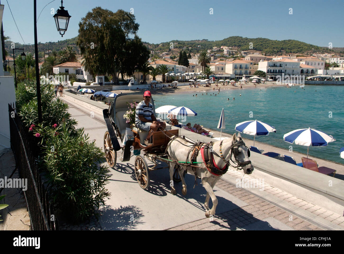 GREECE Saronic Gulf Island of Spetses beach and town with horse drawn ...