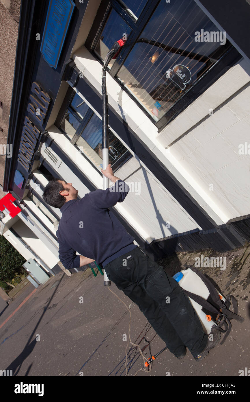 Window cleaner using ionized pure water, fed through a pole and brush ...