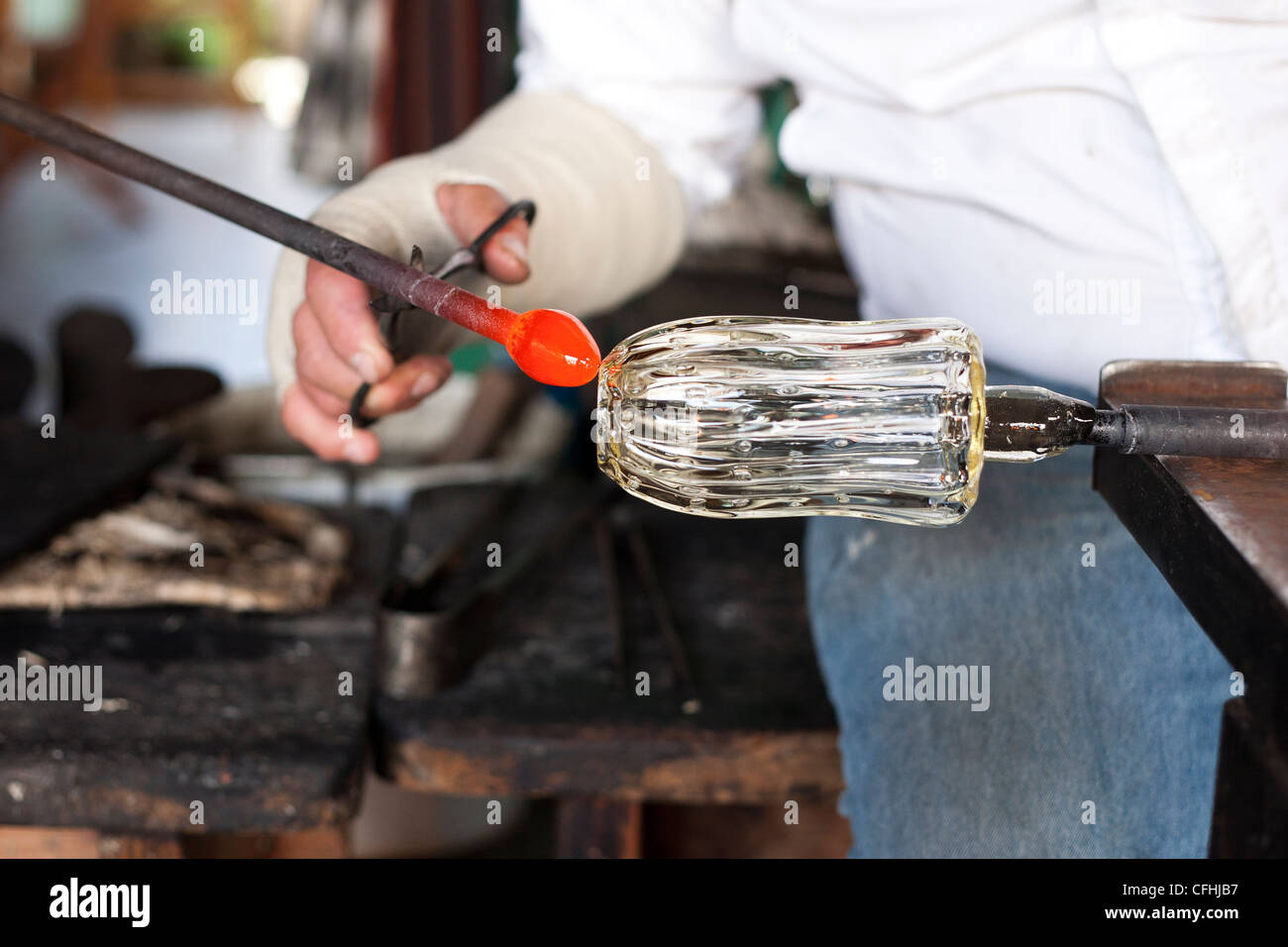 Glass blower shaping molten glass Stock Photo - Alamy