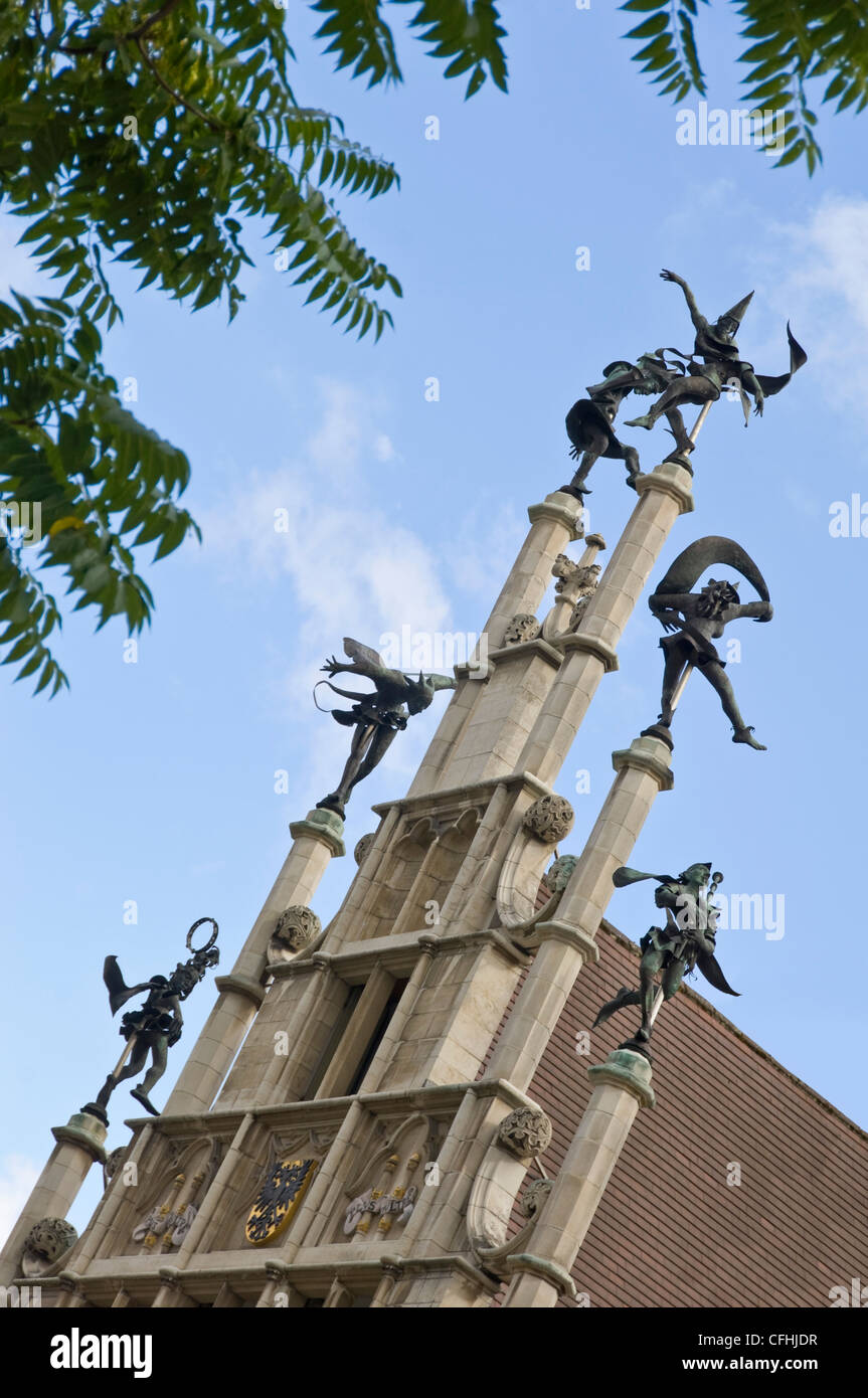 Vertical close up of six dancing devils on the roof of Metselaarshuis ...