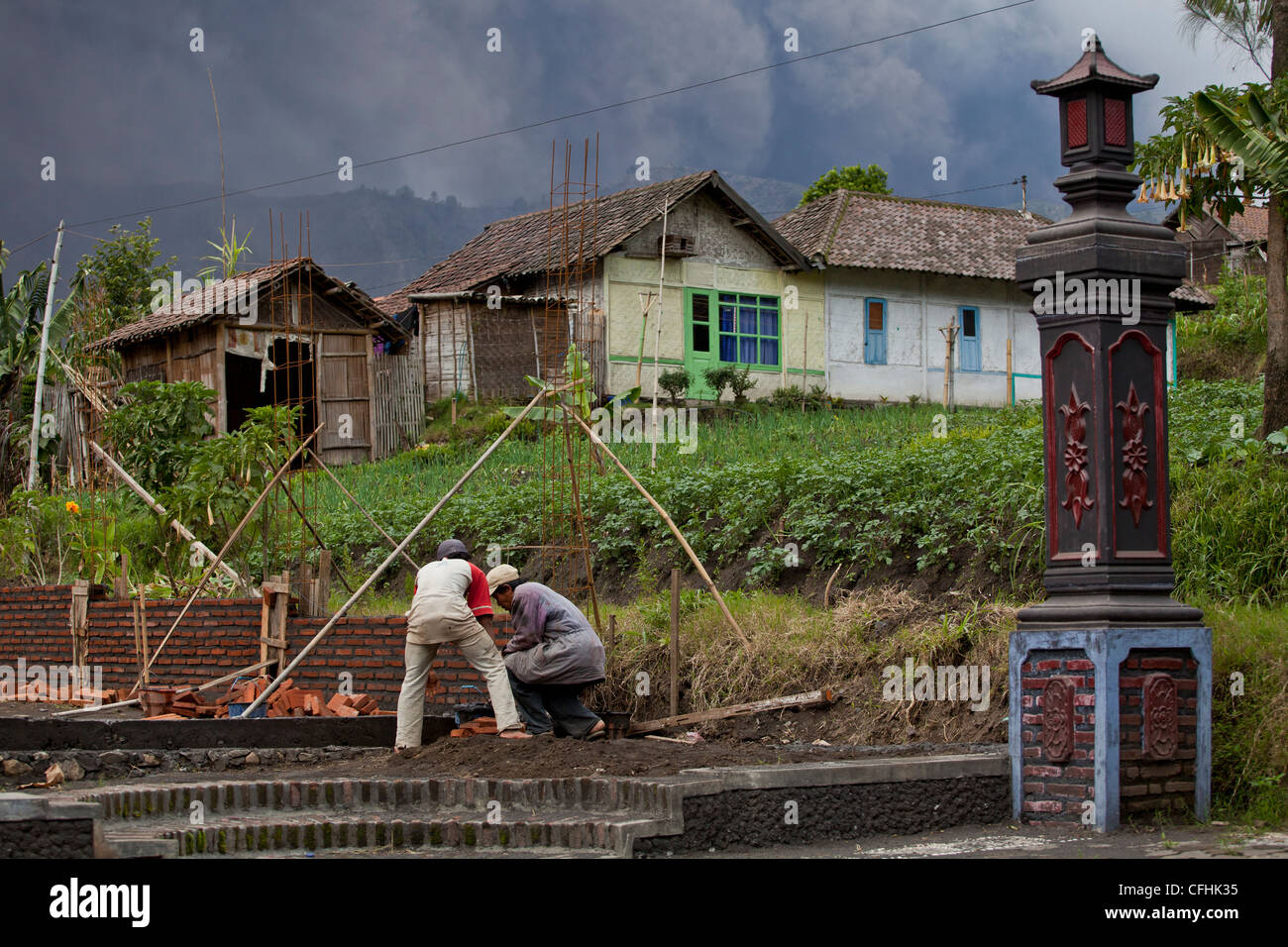Workers and typical house in a Java village near the Bromo volcano ...