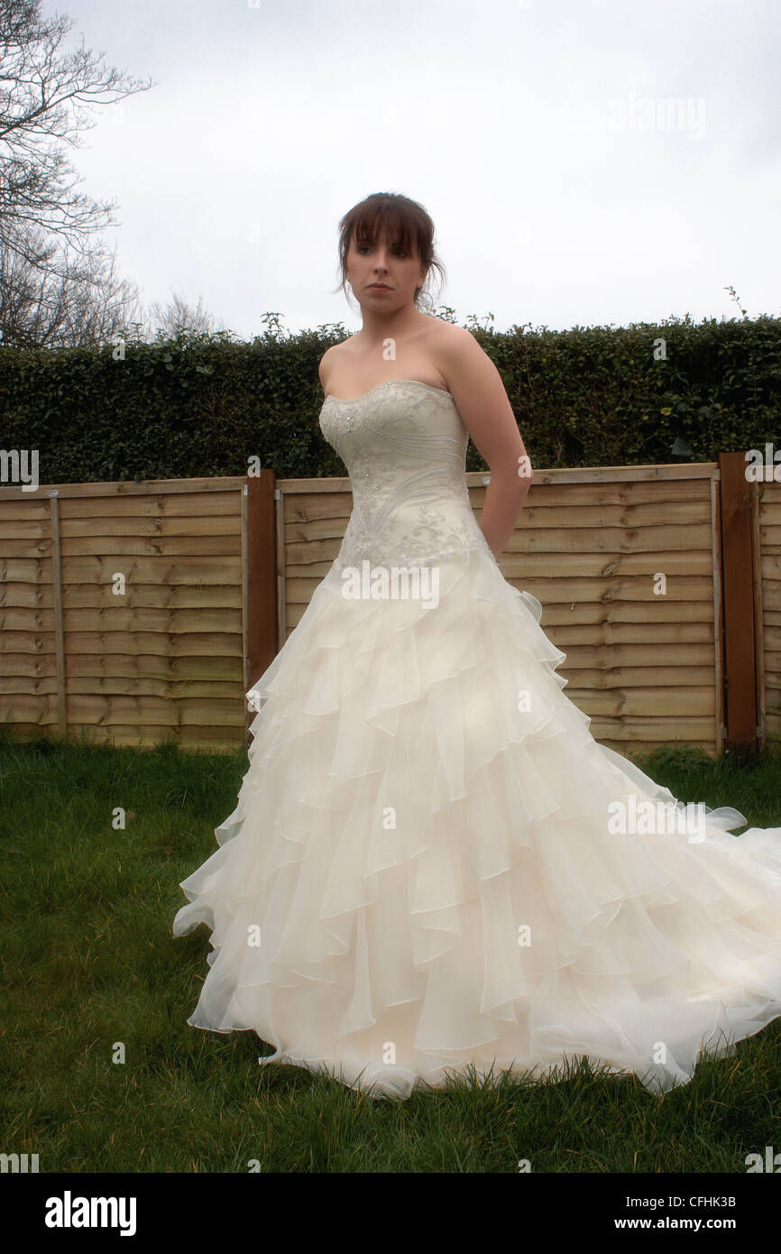 An unhappy Bride standing alone in her wedding dress Stock Photo - Alamy