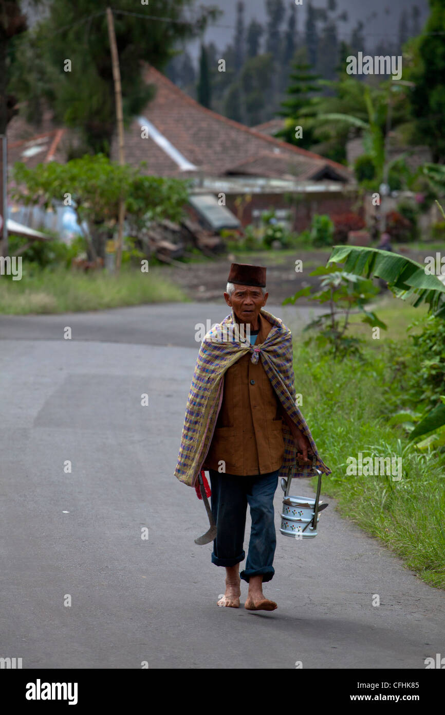 Local worker with traditional clothes in a village of Java, Bromo ...