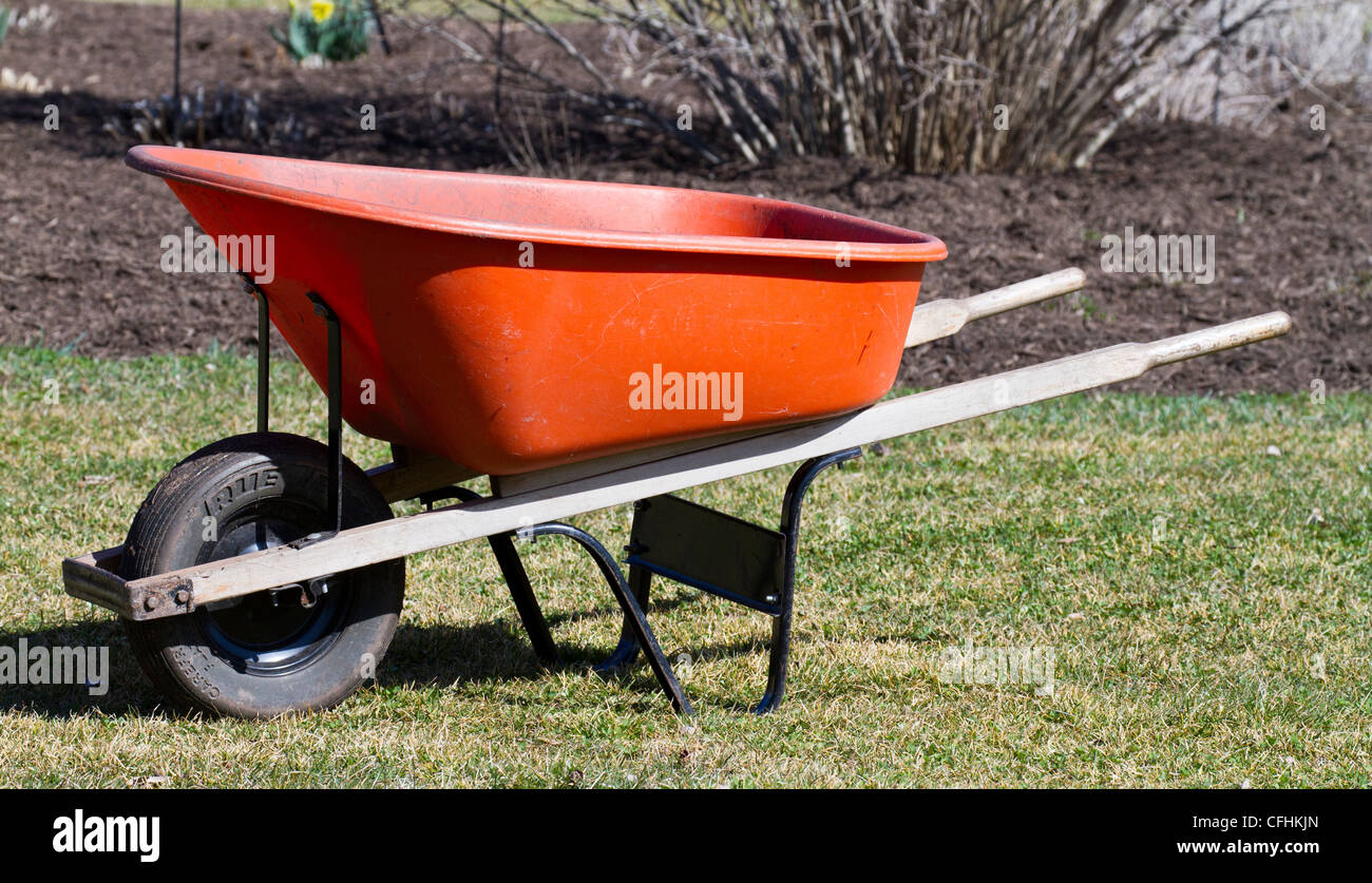 Orange garden wheelbarrow Stock Photo - Alamy
