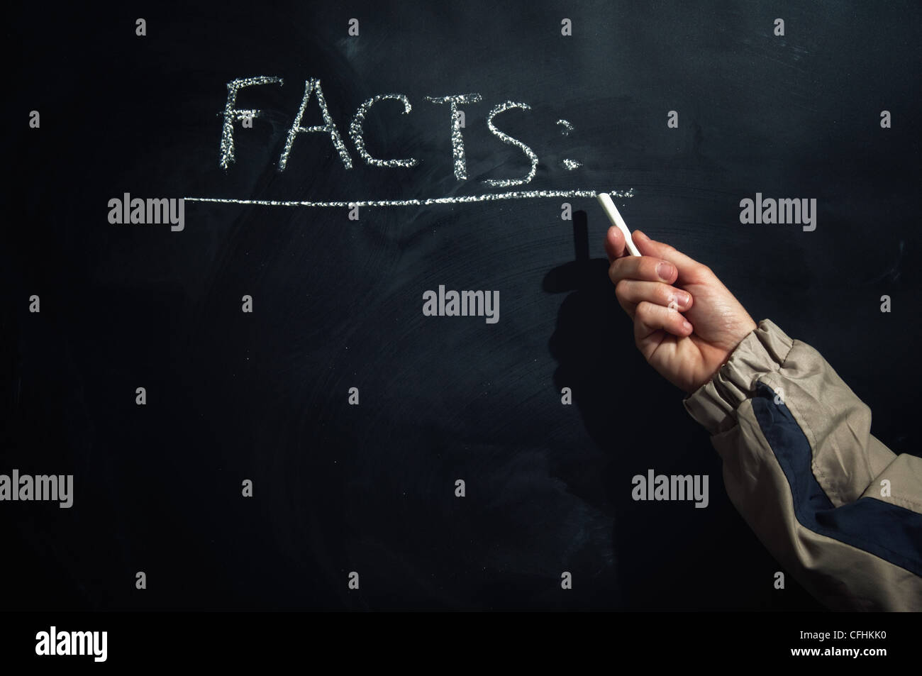 Male hand is writing FACTS with the chalk on the black board Stock ...