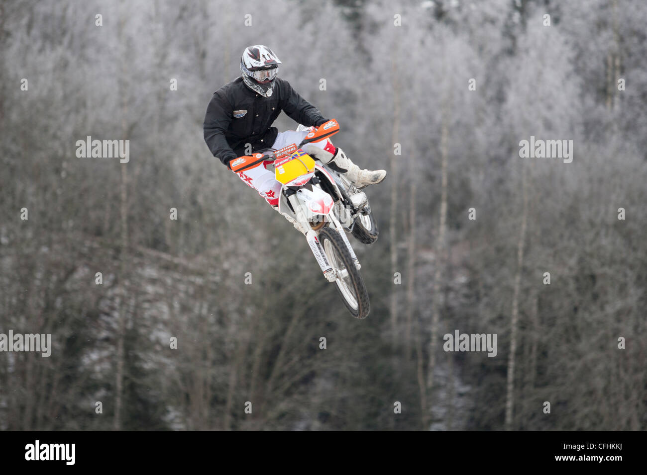 Motocross driver jumping high Stock Photo - Alamy