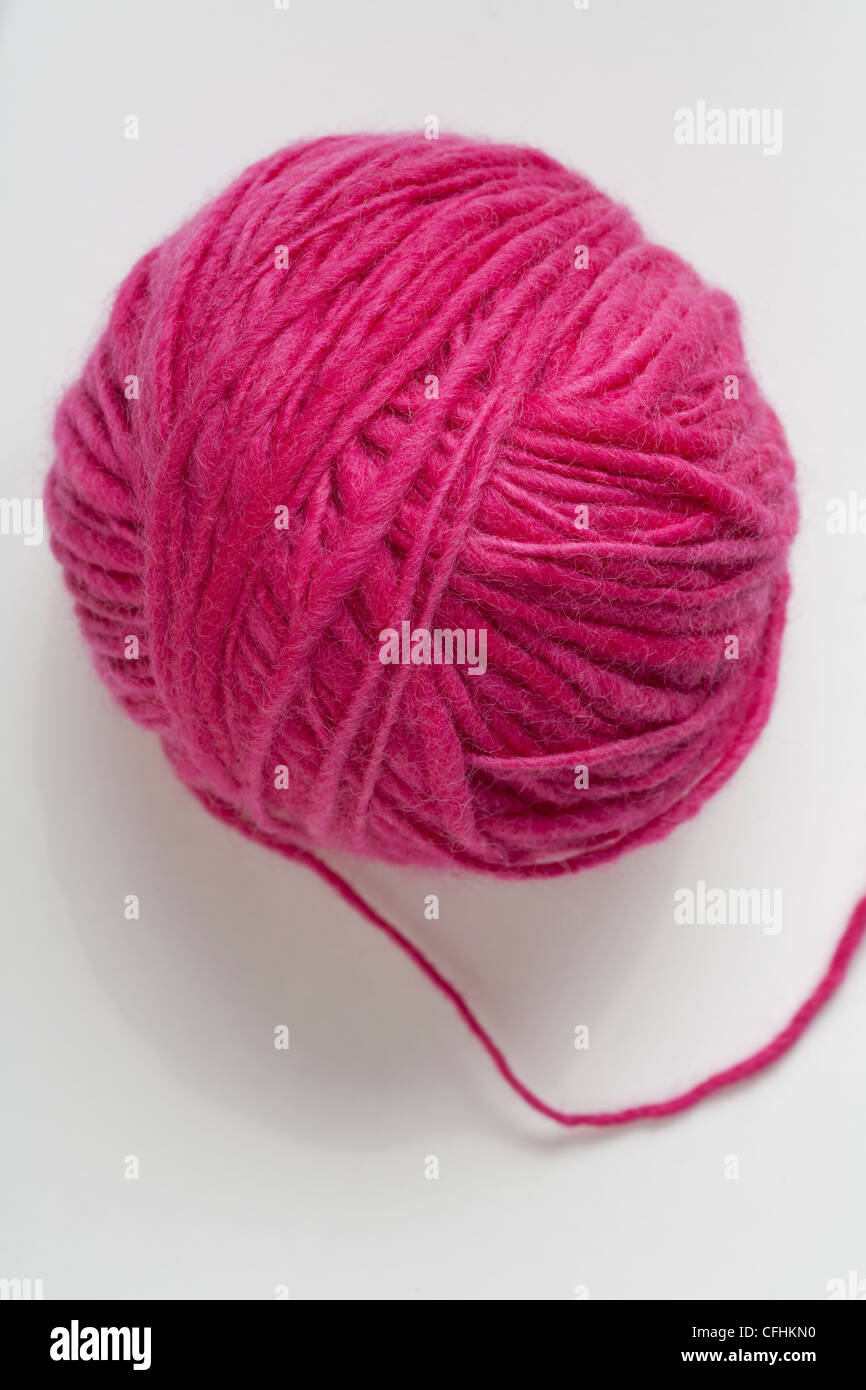 Pink ball of wool yarn on white Stock Photo - Alamy