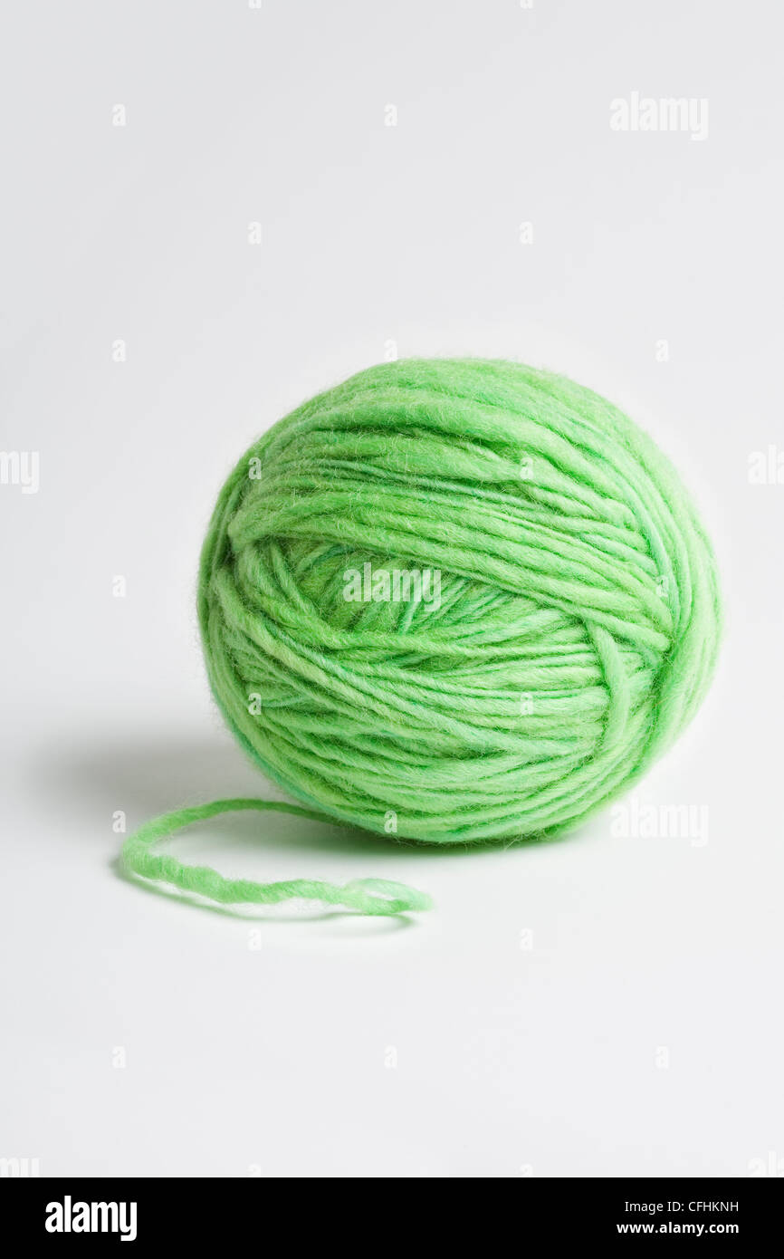Ball of green wool yarn on white Stock Photo - Alamy