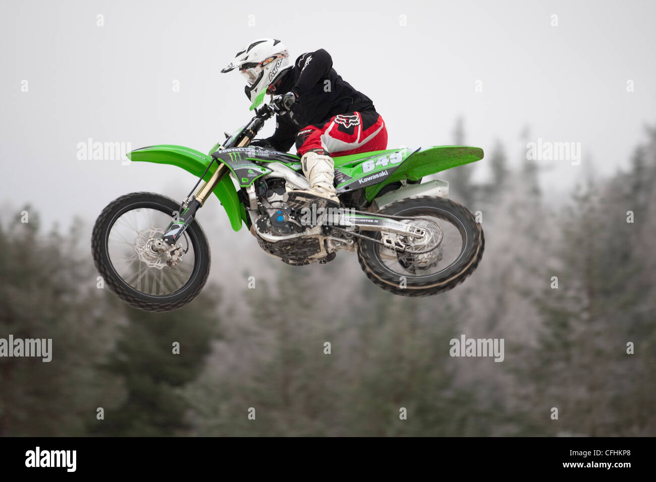 Motocross driver jumping high Stock Photo - Alamy