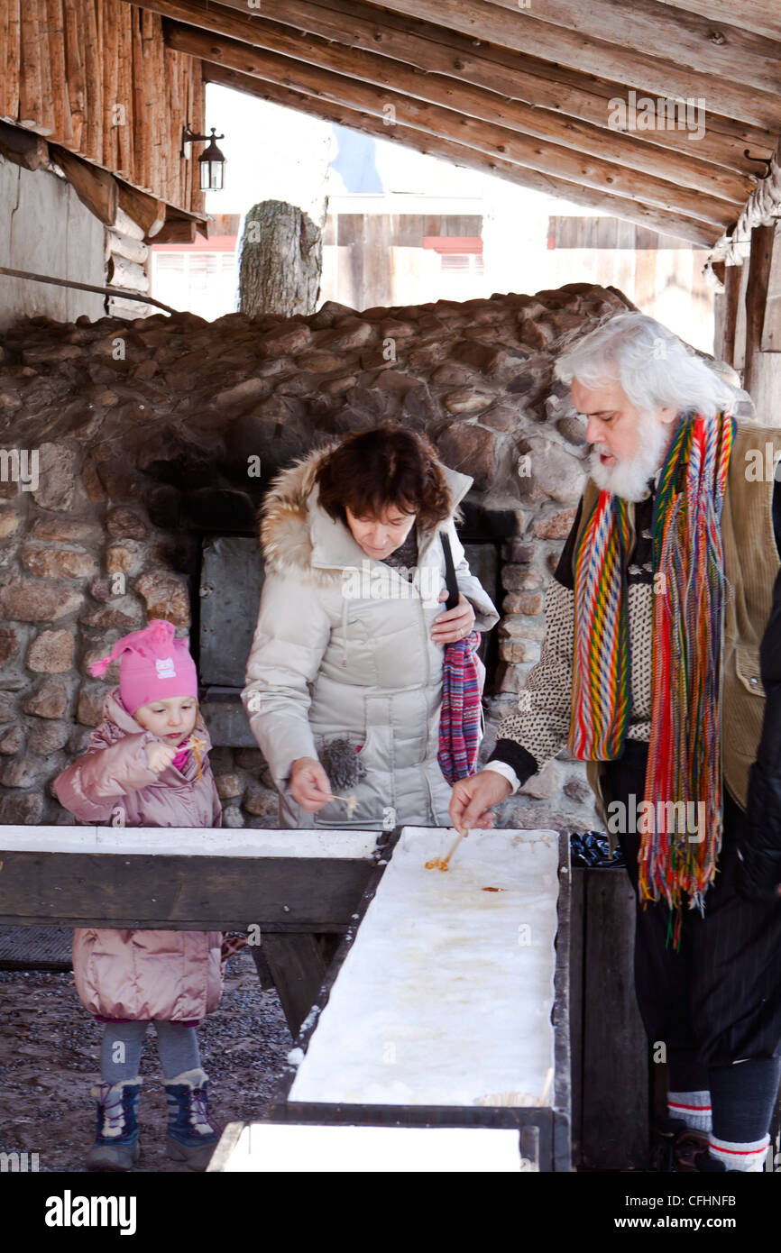 Maple syrup on snow,maple taffy,maple syrup Quebec Stock Photo - Alamy