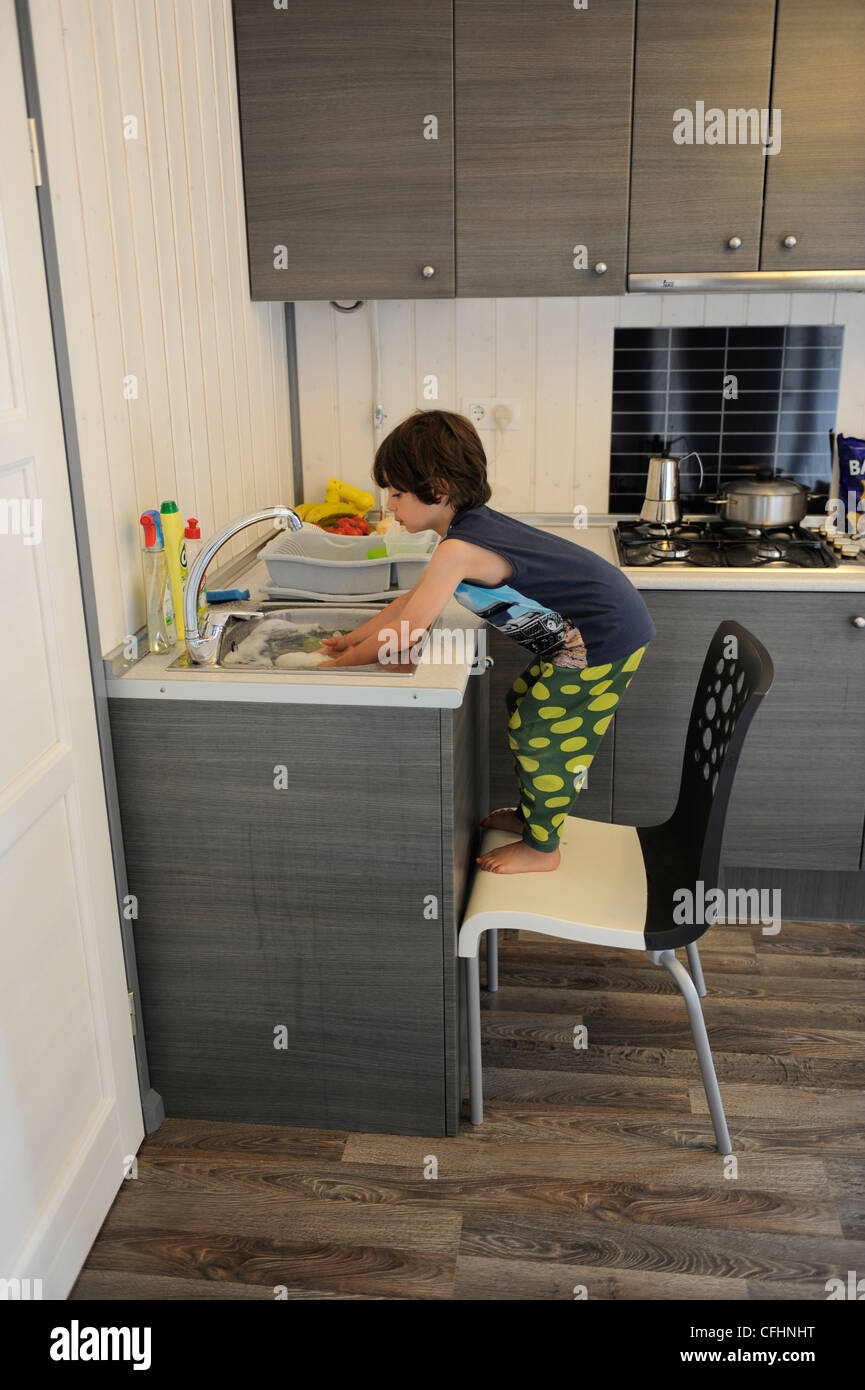 Boy washing the dishes Stock Photo - Alamy