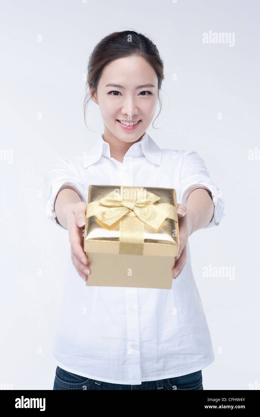 The woman giving gold gift box Stock Photo - Alamy