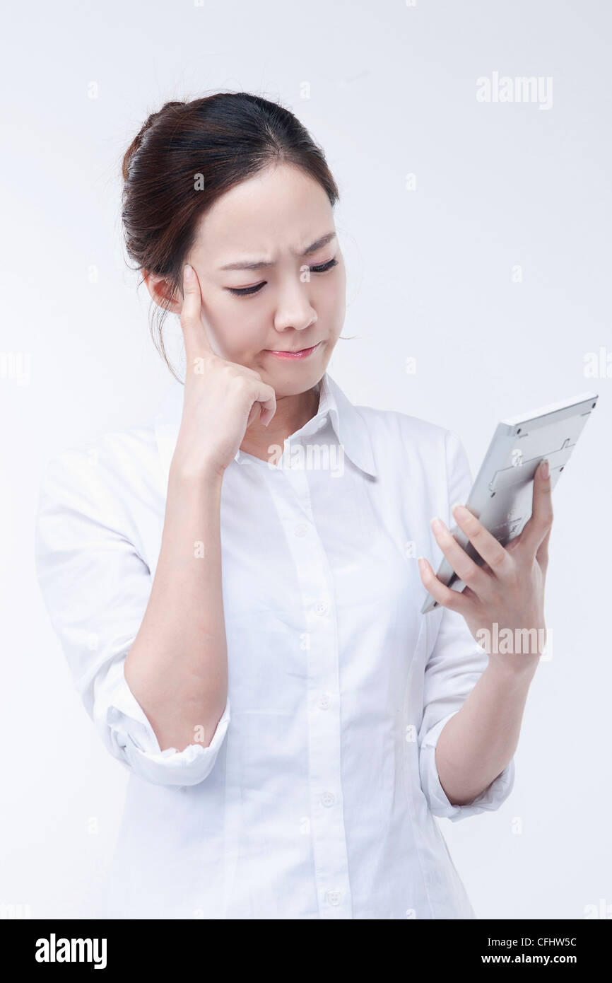 The thinking woman with a calculator Stock Photo - Alamy
