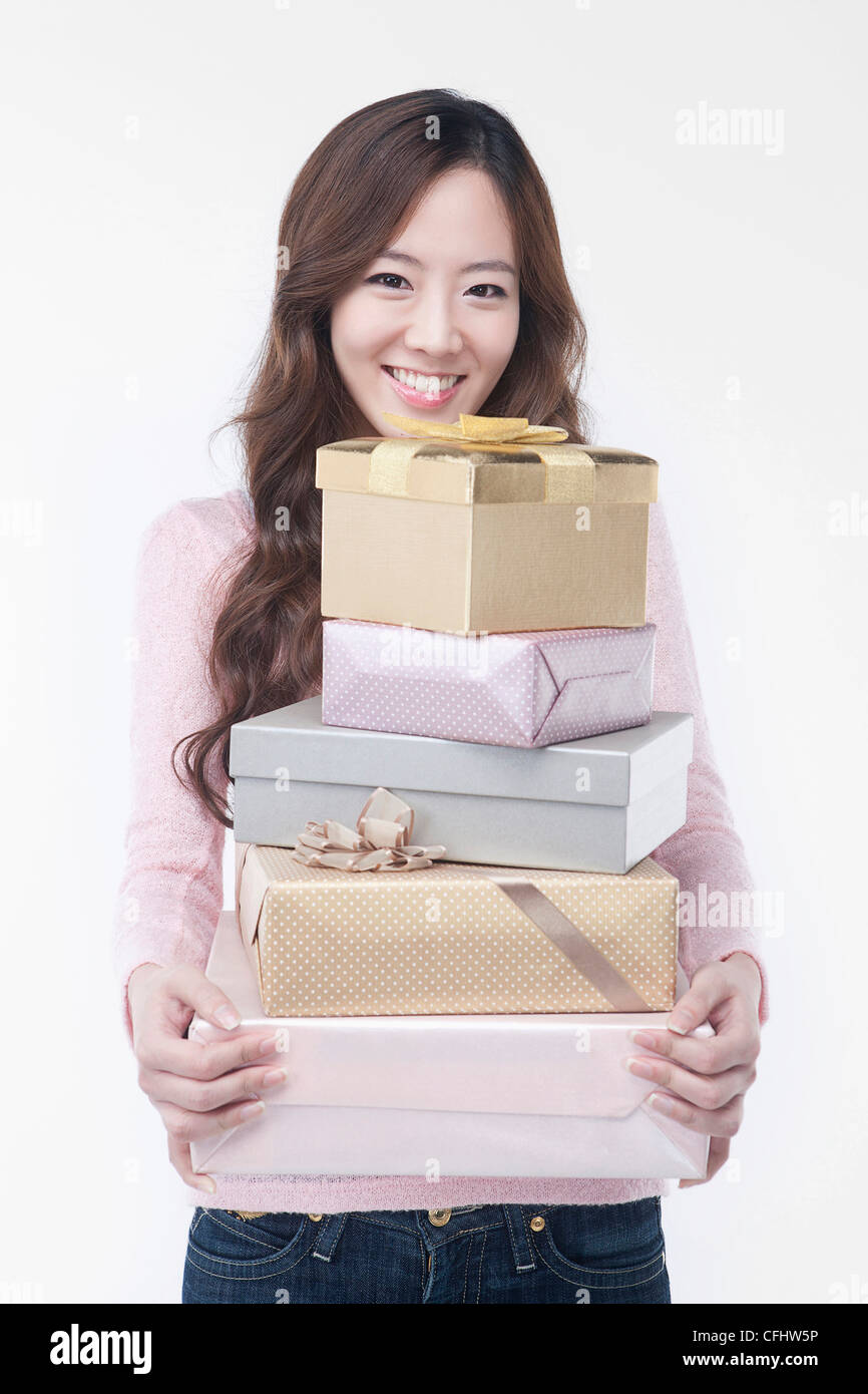 The woman with piled gift boxes Stock Photo - Alamy