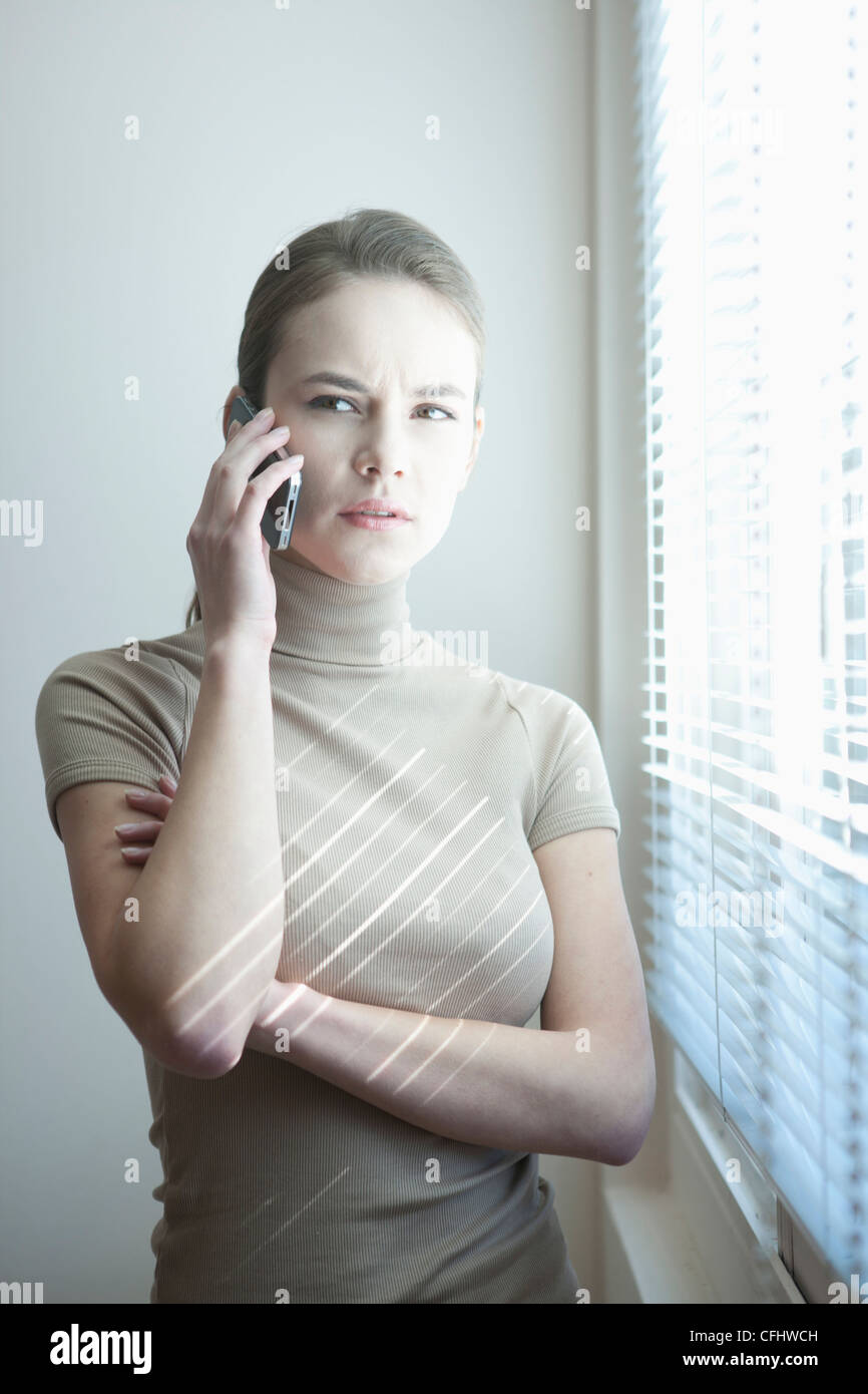 The woman talking on the phone by the window Stock Photo - Alamy