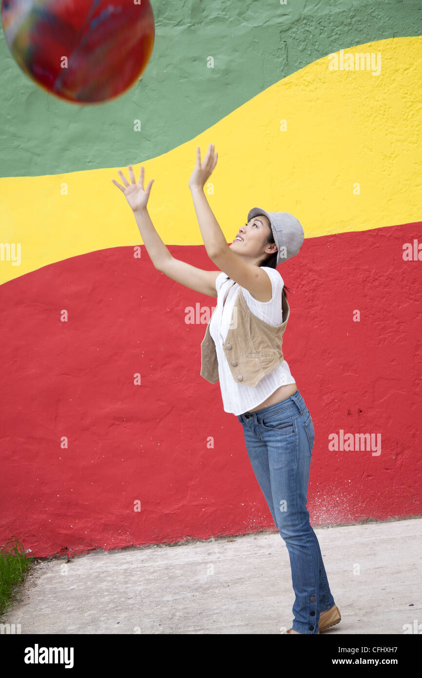 Young woman throwing a big ball Stock Photo - Alamy
