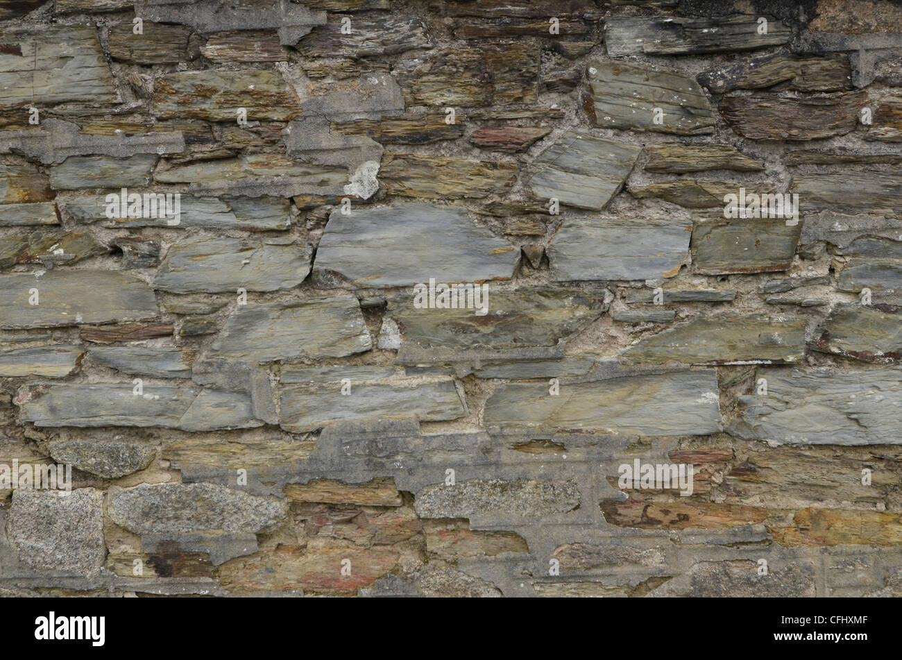 Stone building wall beginning to crumble and flake away. Visual ...