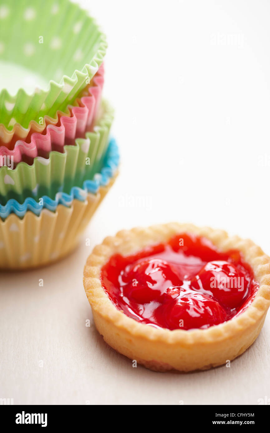 The colorful polka dots patterned baking cups and cherry jam tart Stock ...