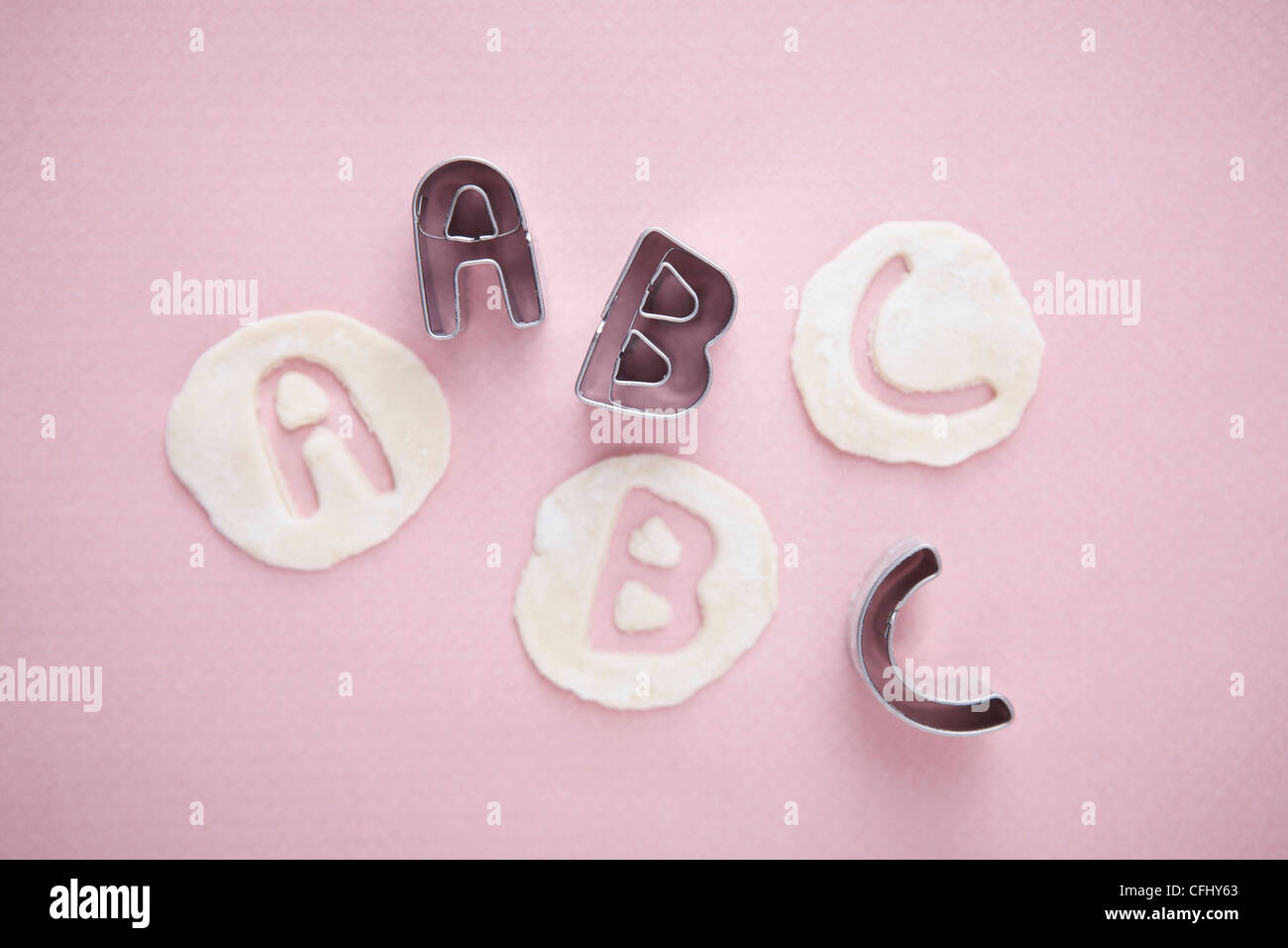The alphabet shaped cookie cutters and the dough Stock Photo - Alamy
