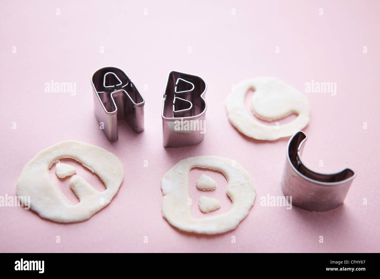 The alphabet shaped cookie cutters and the dough Stock Photo - Alamy
