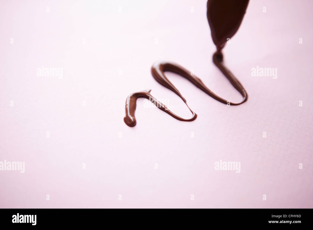 The melted chocolate line with the decorating bag Stock Photo - Alamy