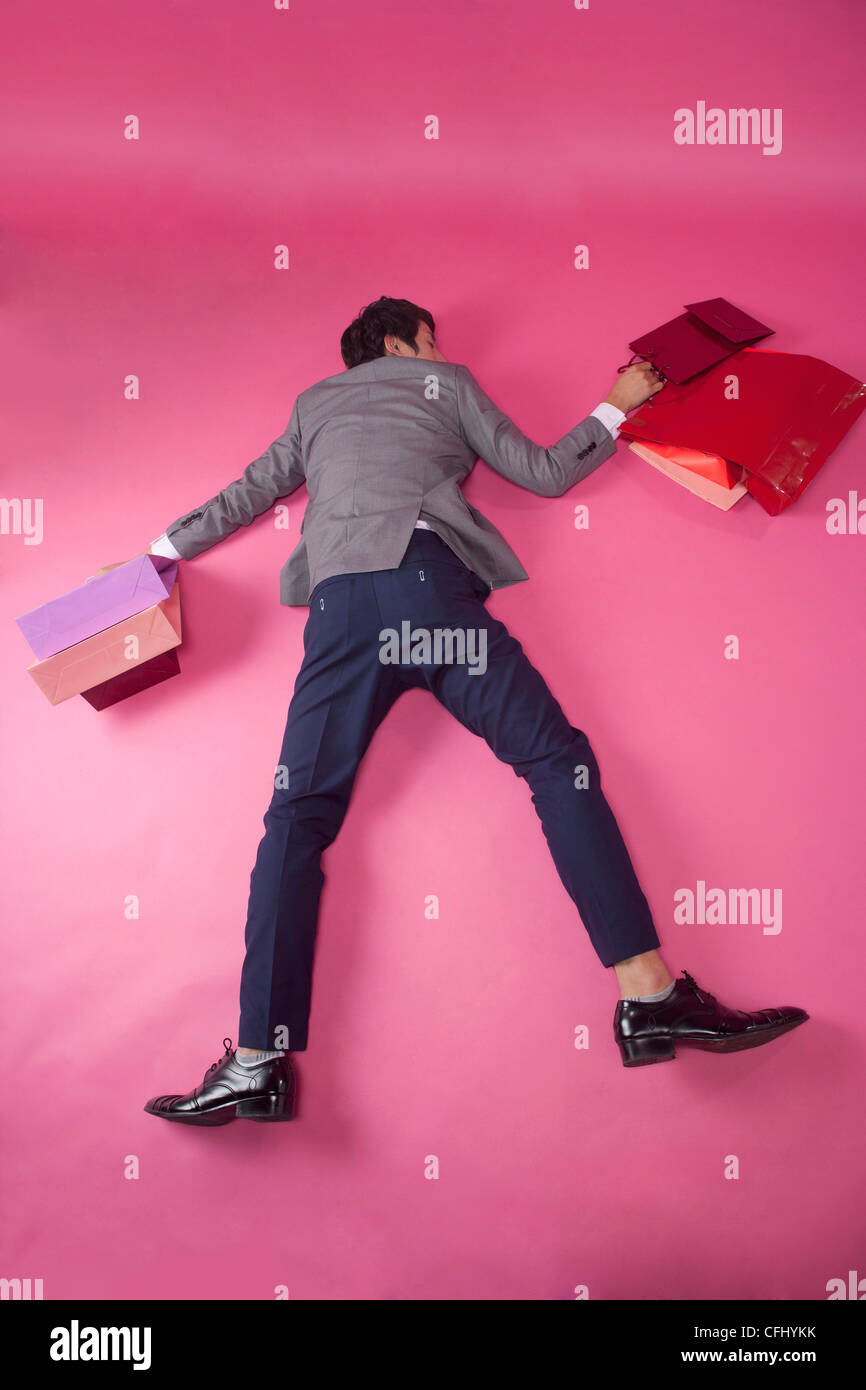 A fell down man with many shopping bags around Stock Photo - Alamy