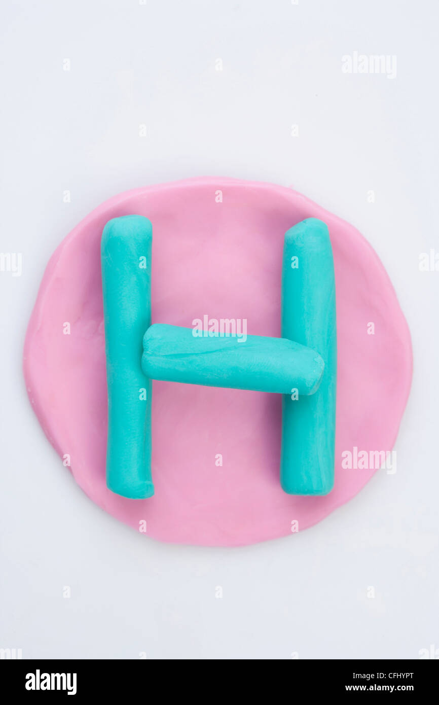 The alphabet H shaped blue clay on the pink circle clay Stock Photo - Alamy