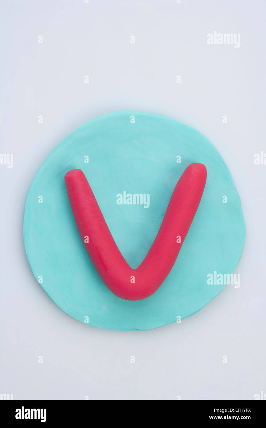 The alphabet V shaped red clay on the blue circle clay Stock Photo - Alamy