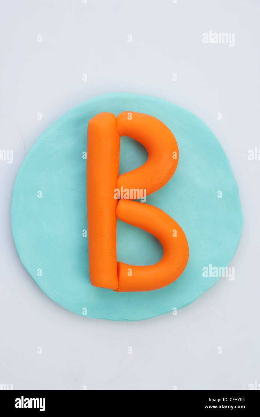 The alphabet B shaped orange clay on the blue circle clay Stock Photo ...