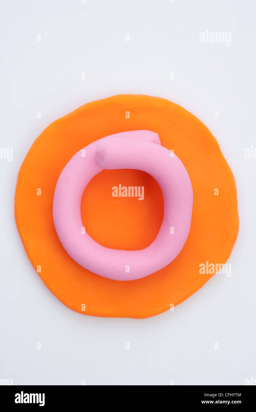 The alphabet O shaped pink clay on the orange circle clay Stock Photo ...