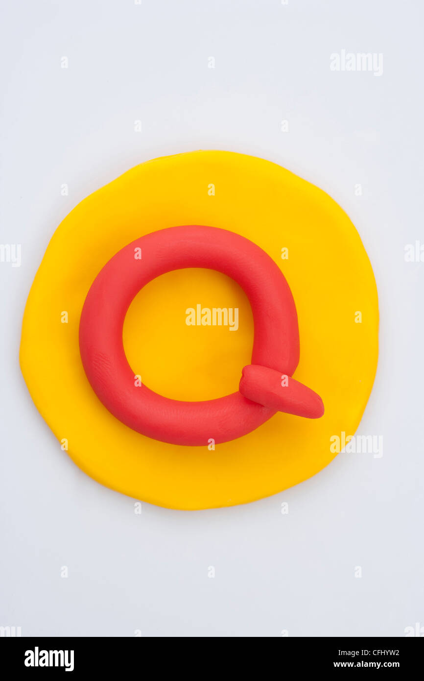 The alphabet Q shaped red clay on the yellow circle clay Stock Photo ...