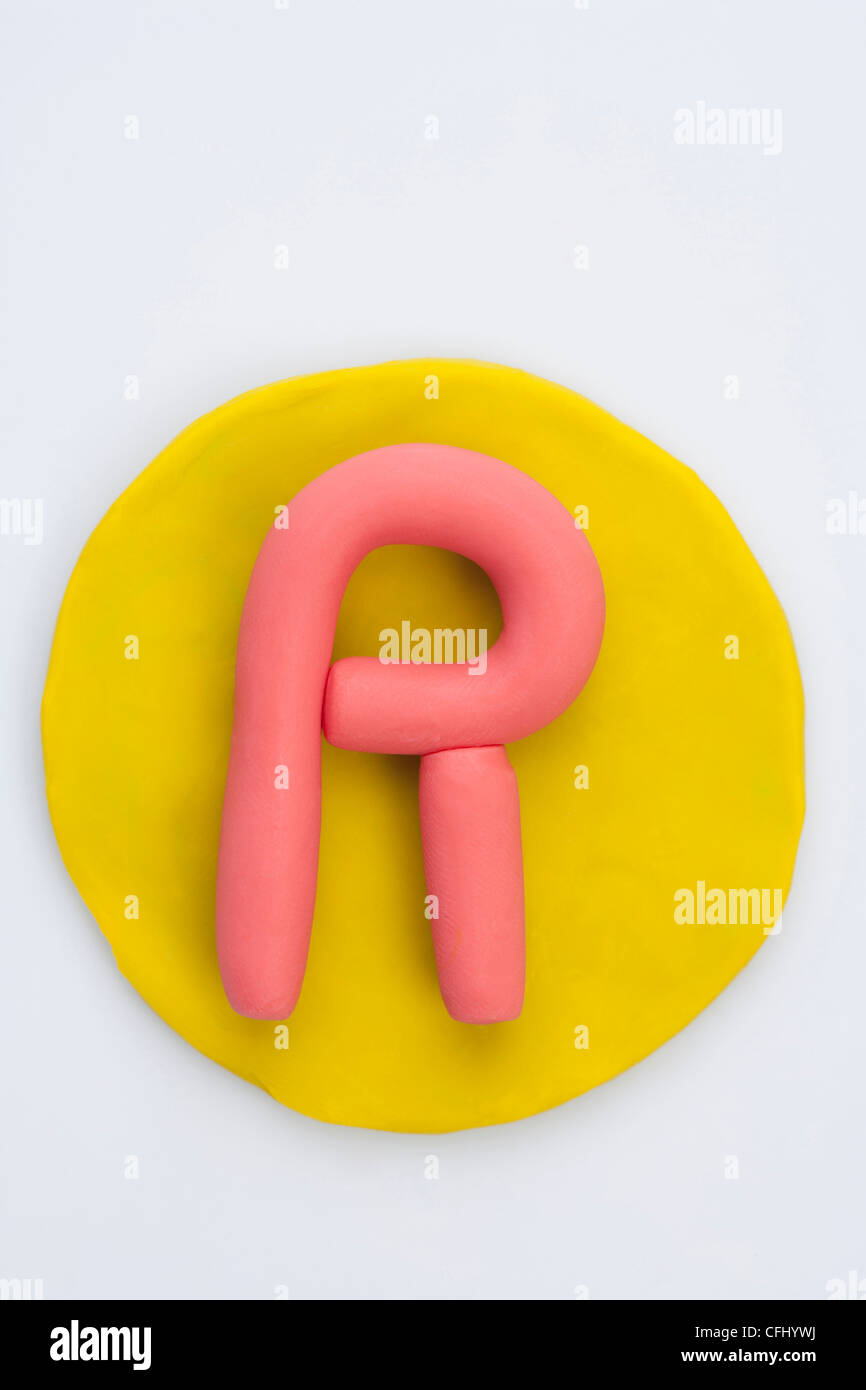 The alphabet R shaped orange clay on the yellow circle clay Stock Photo ...