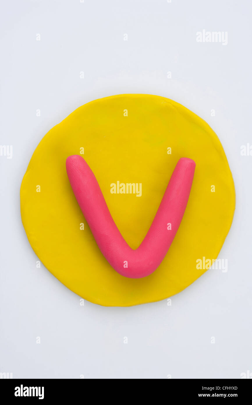 The alphabet V shaped red clay on the yellow circle clay Stock Photo ...