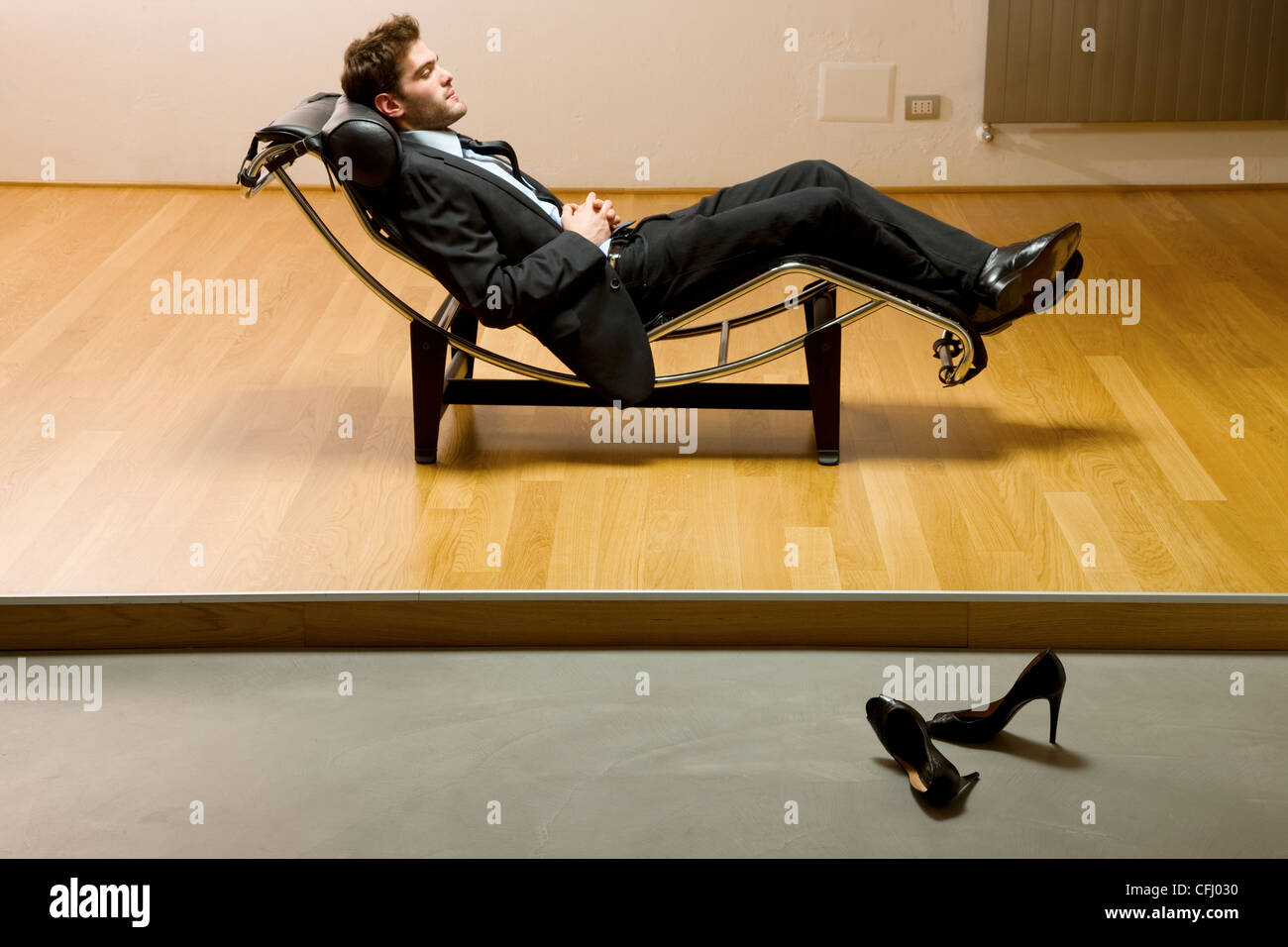 man lying on chaise longue Stock Photo - Alamy