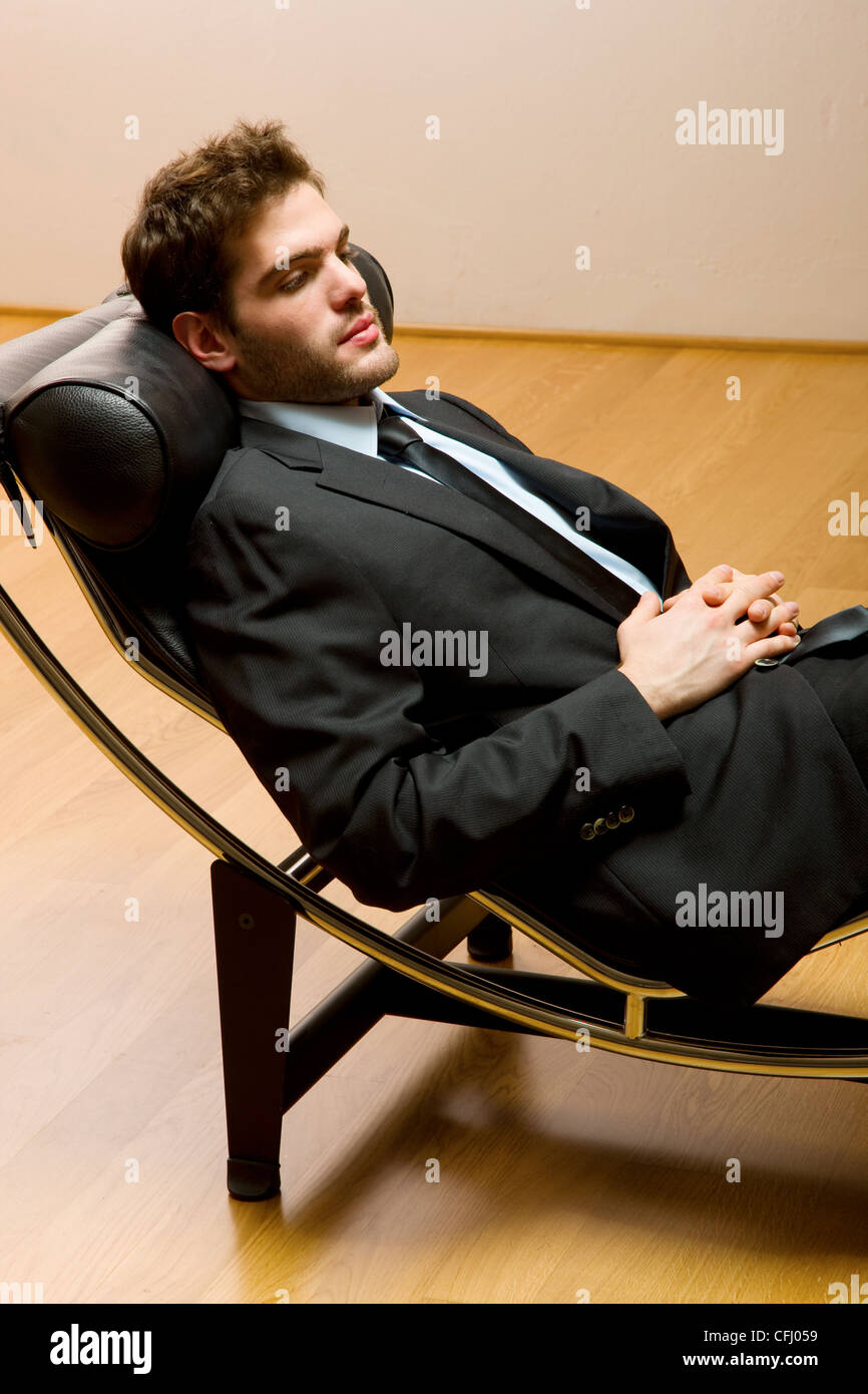 man lying on chaise longue Stock Photo - Alamy
