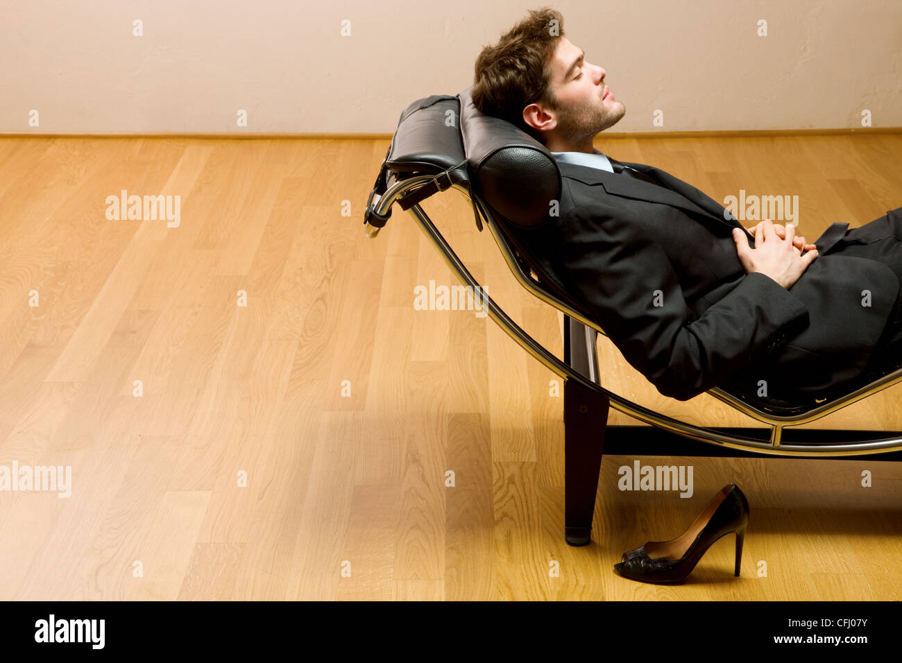 man lying on chaise longue Stock Photo - Alamy