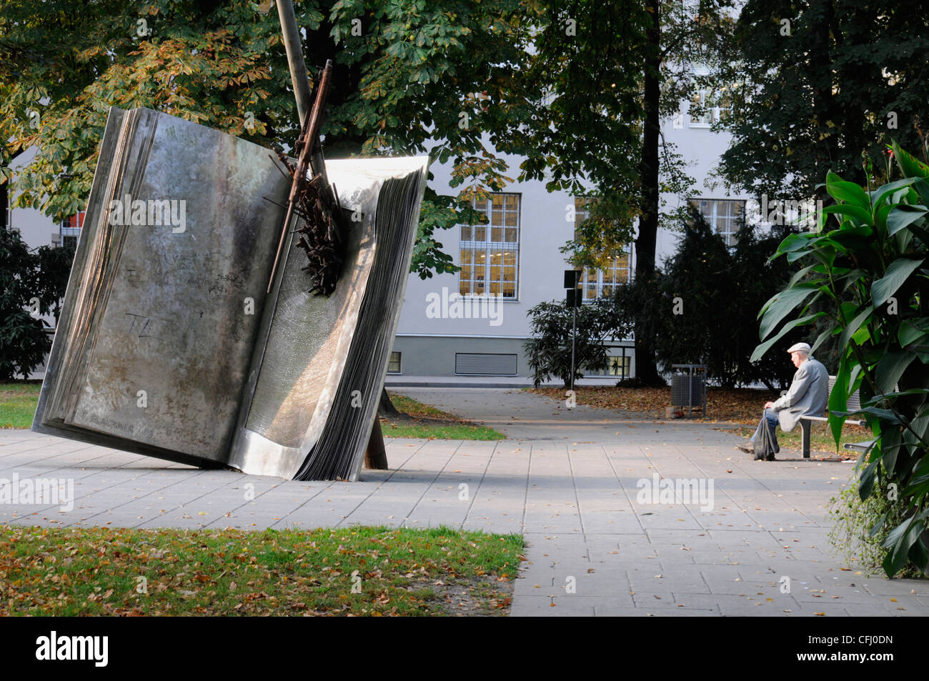 A resident sitting in one of the parks admiring a giant book in Linz ...