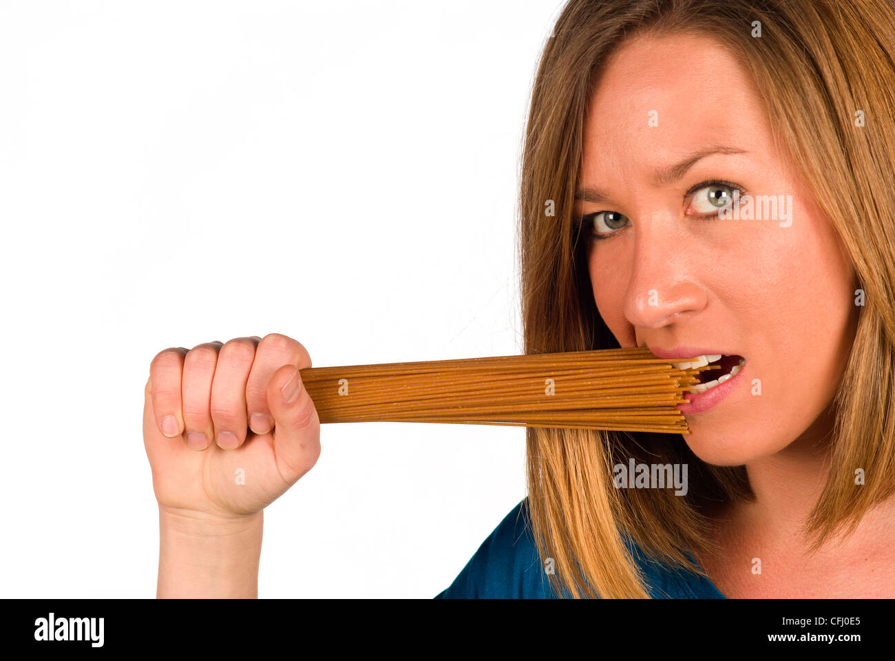 Biting into whole wheat pasta, a healthy nutrition concept Stock Photo ...