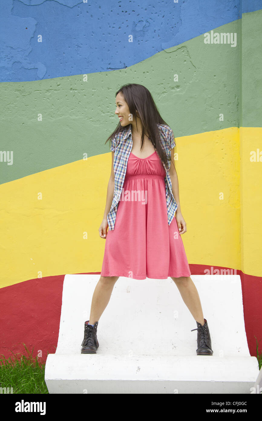 Young woman standing on a bench Stock Photo - Alamy