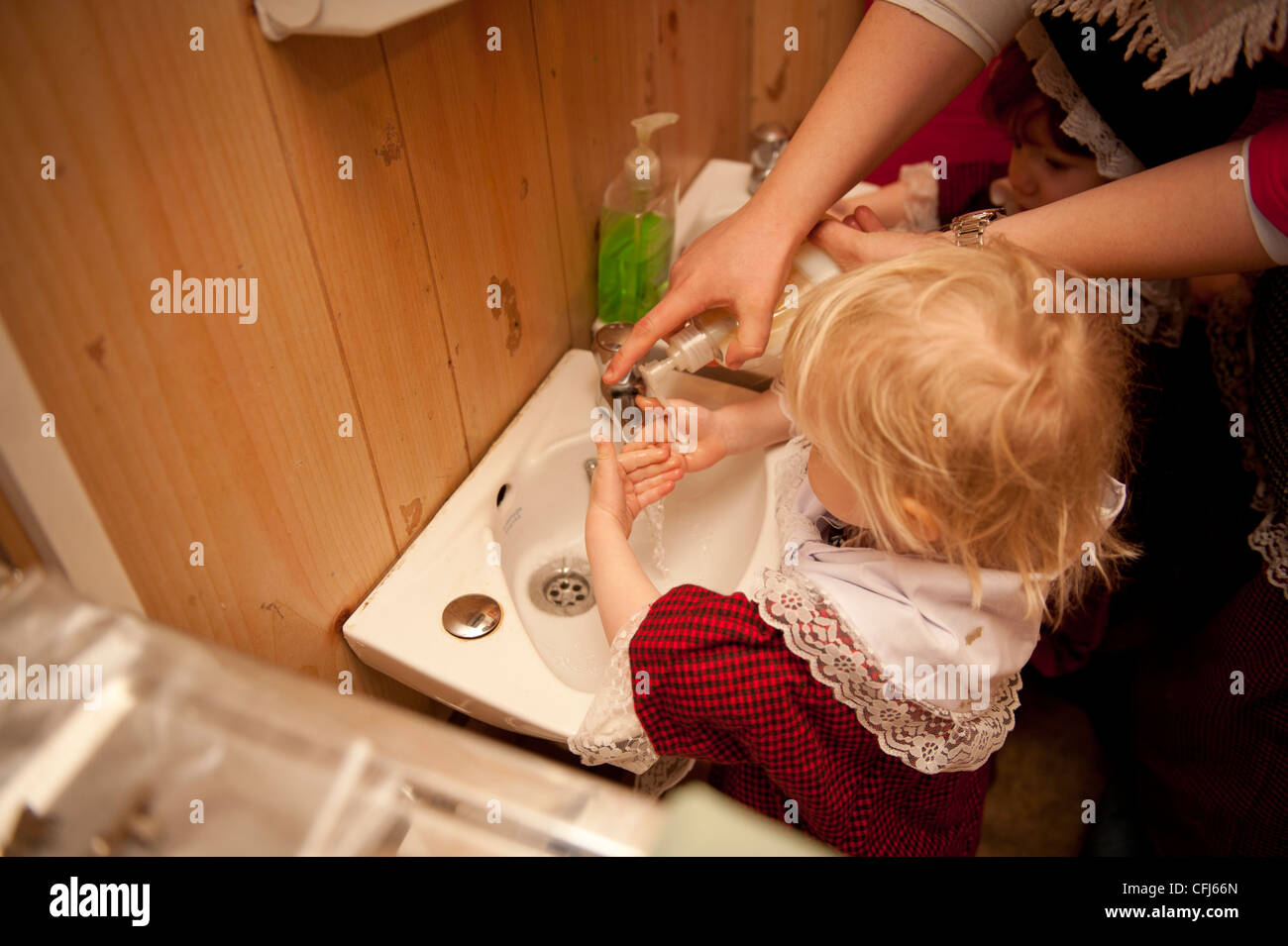 a child washing her hands at a nursery school kindergarten pre-school ...